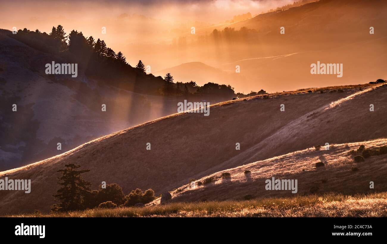 Sunset landscape with sun rays illuminating hills and valleys in Santa ...