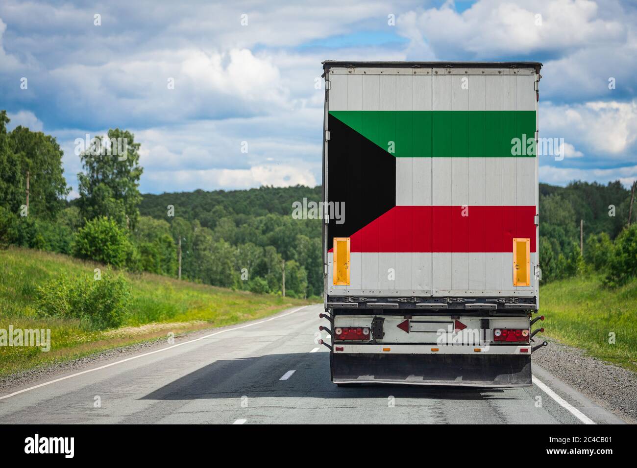 A truck with the national flag of Kuwait depicted on the back door ...