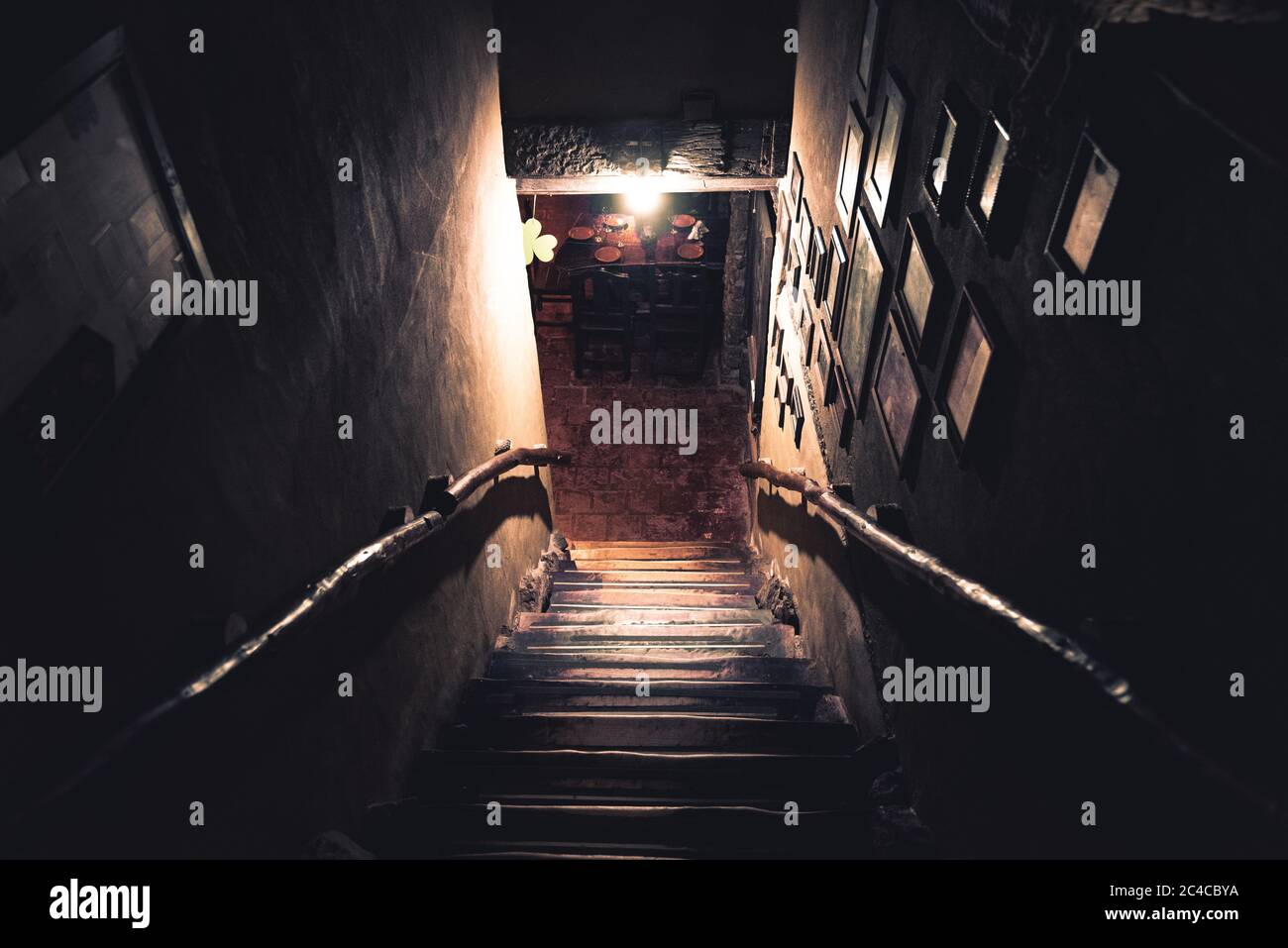 Dramatic point of view of scary stairs from upside into darkness of ...