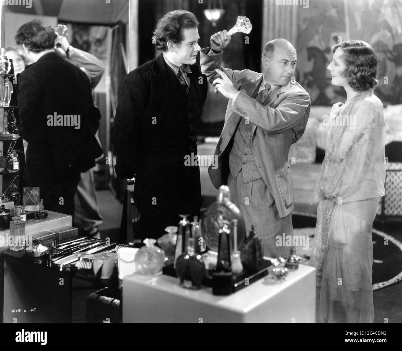 Director CECIL B. DeMILLE shows KAY JOHNSON how to hit CHARLES BICKFORD ...