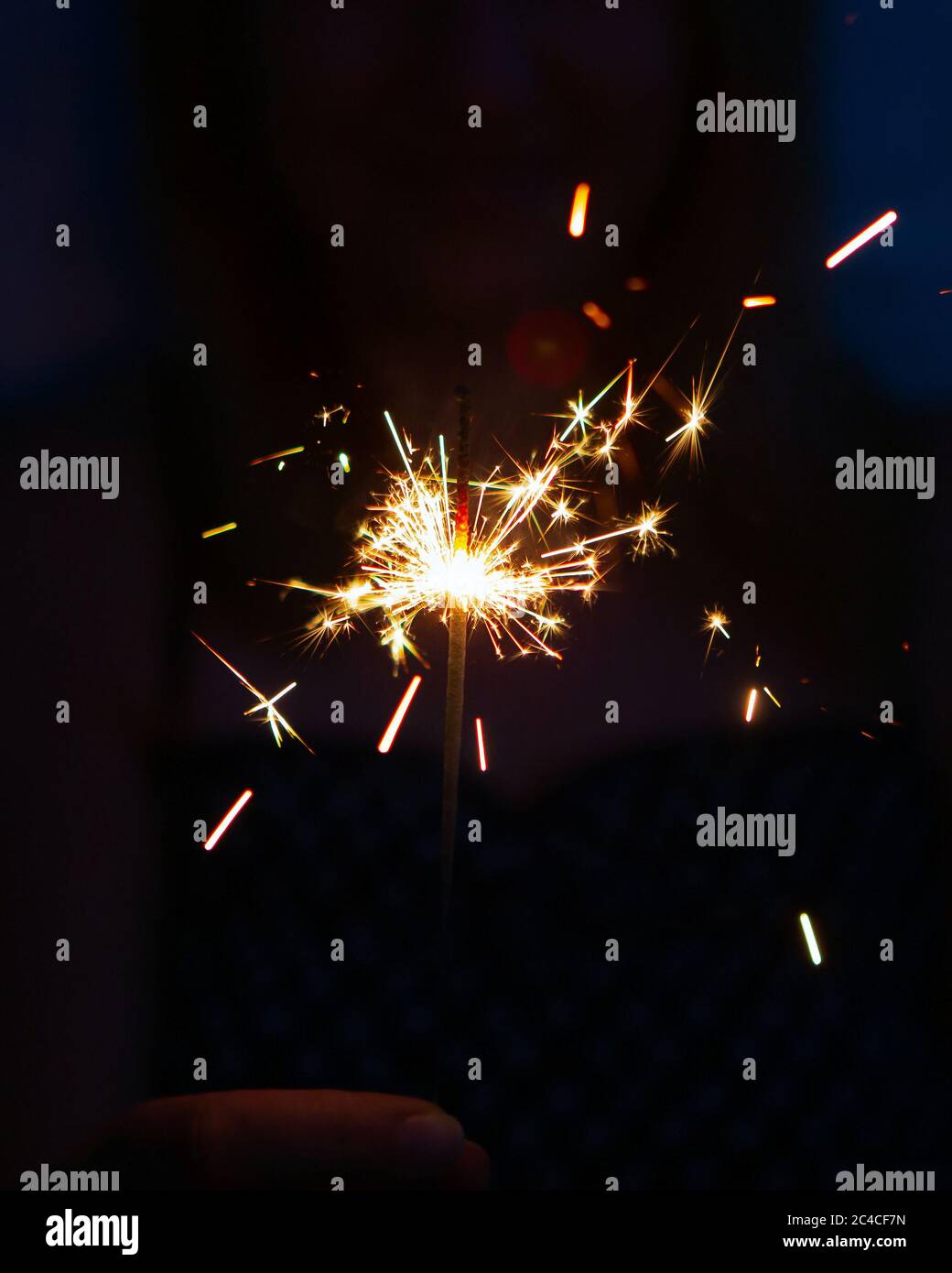 Lighting a Colorful Firework Sparkler In Celebration of the Holidays ...