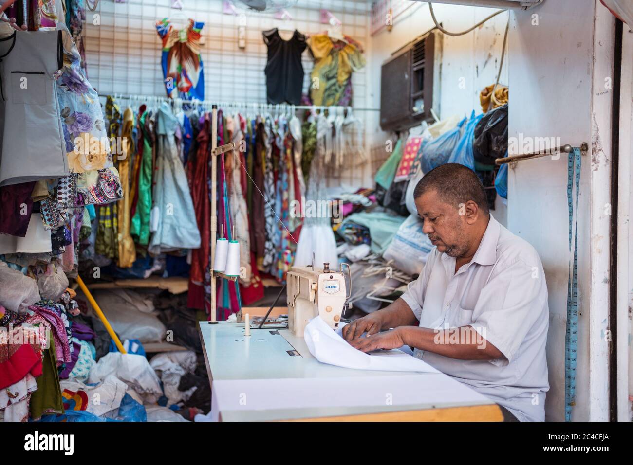 Muscat / Oman - February 15, 2020: tailor sewing in small shop at ...