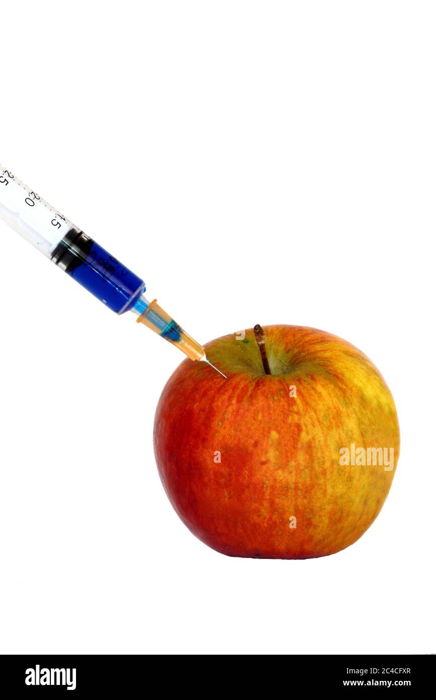 Apple being injected with chemicals Stock Photo - Alamy