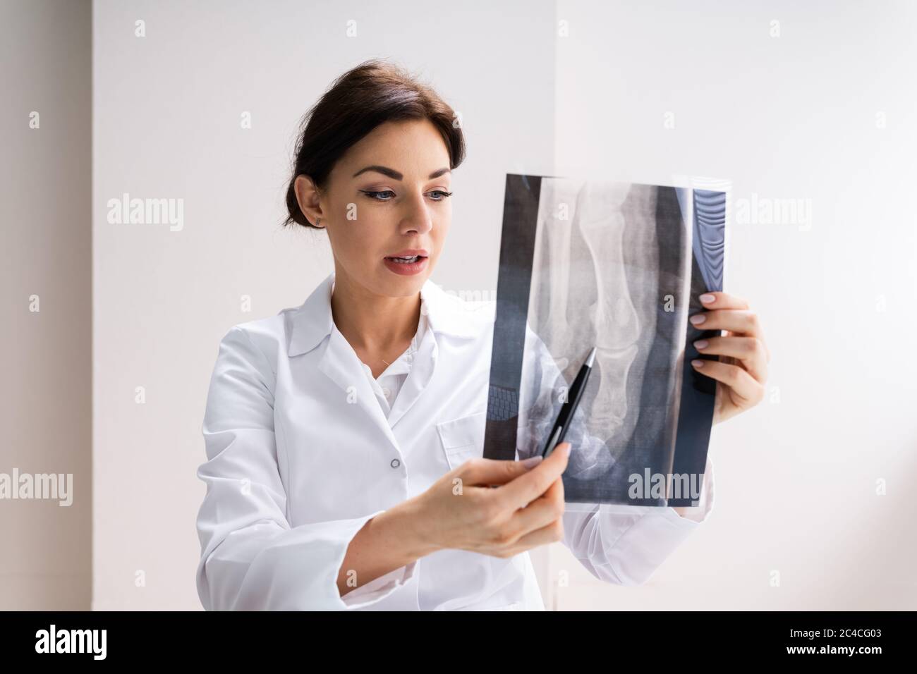 Female Doctor Holding Xray Scan Image In Hospital Stock Photo - Alamy