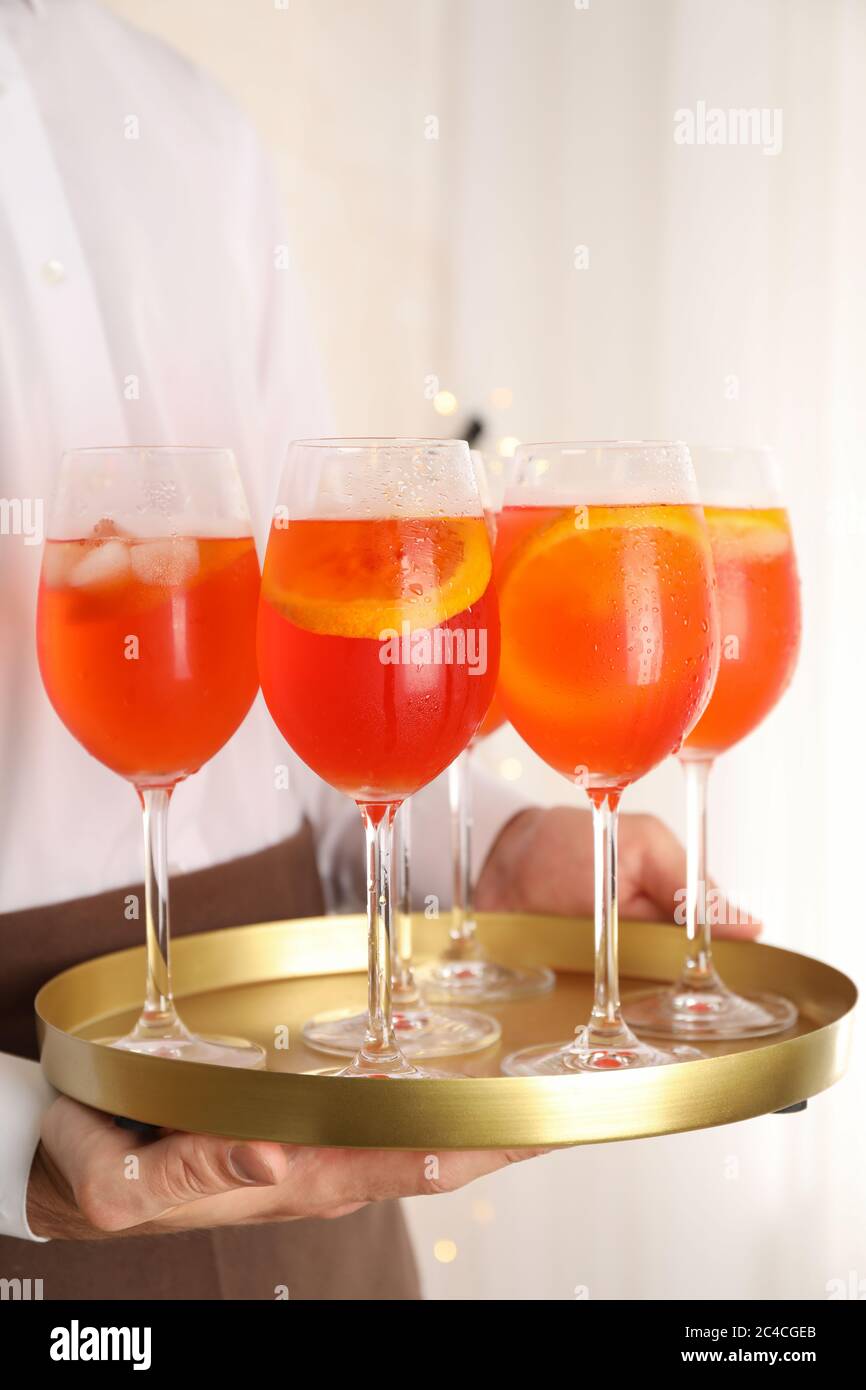Waiter holding tray with aperol spritz cocktail. Summer drink Stock ...