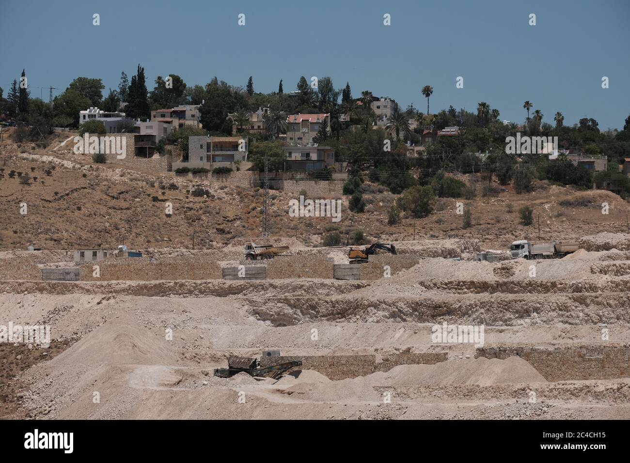 Bulldozer and trucks clearing land in the Jewish settlement of Kfar ...