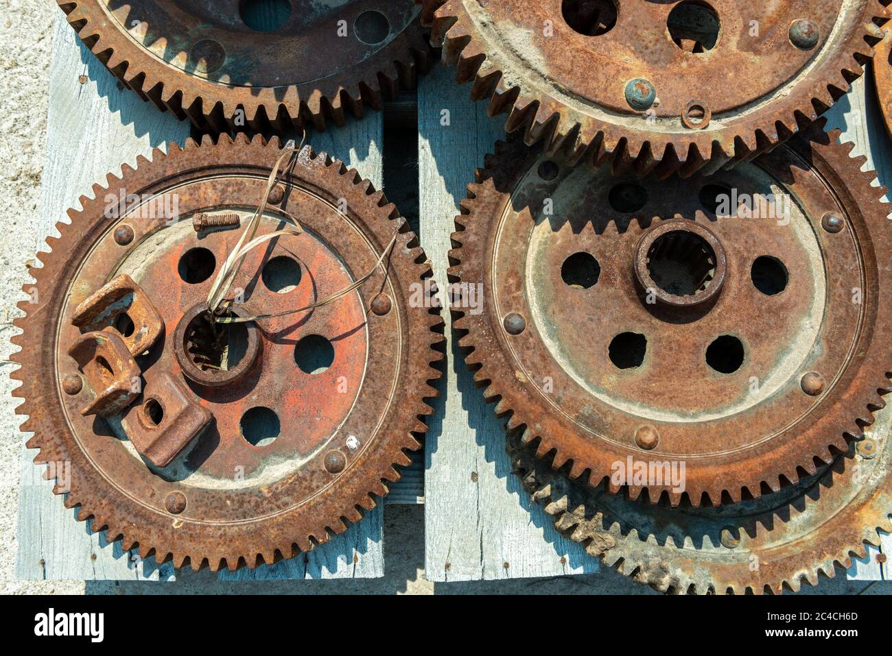 Rusty gears laying on a wood pallet Stock Photo - Alamy