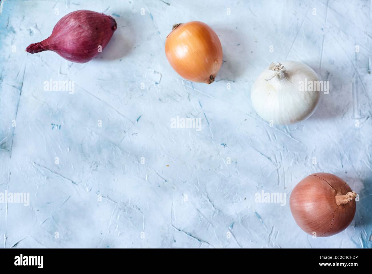 Cleaning fresh onions in the kitchen. Top view Stock Photo - Alamy