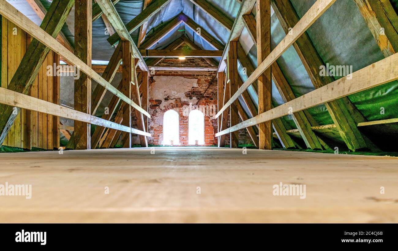picture with wooden beams and windows in the roof attic, view out the ...