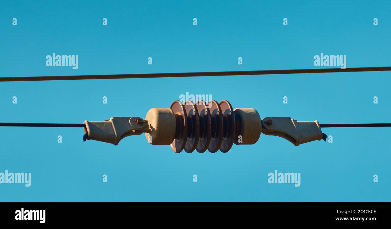 Cable and wire with a ceramic insulator against a blue sky Stock Photo ...