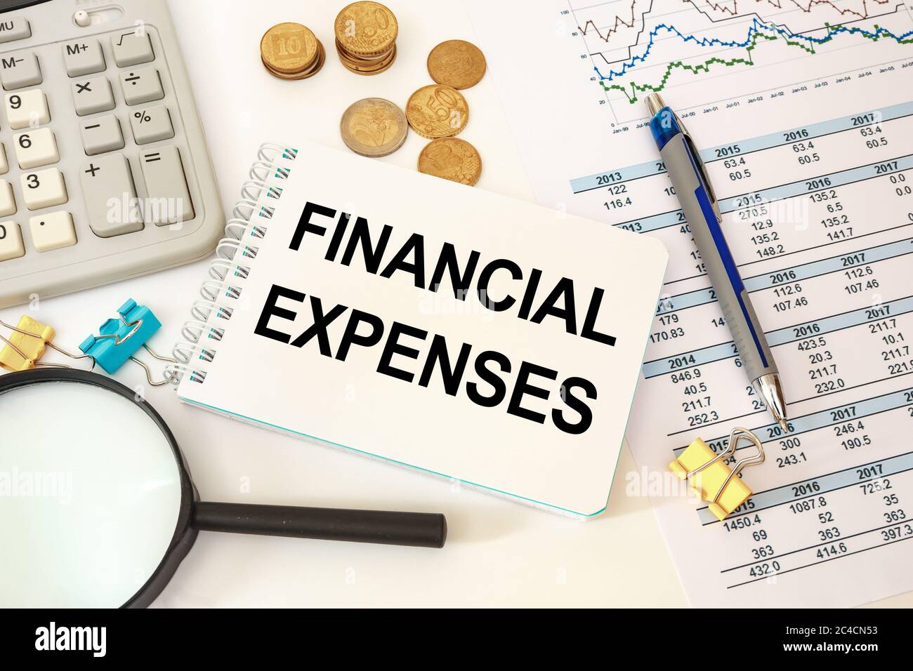 Business concept - workspace office desk and notebook writing FINANCIAL ...