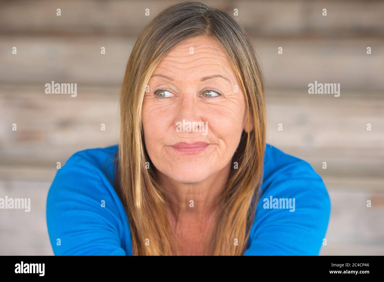 Portrait attractive mature woman with shy cheeky facial expression ...