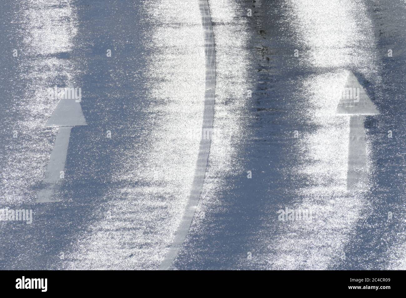 Directional arrow on rain wet road hi-res stock photography and images ...