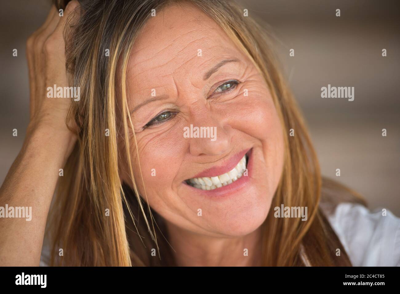 Portrait attractive mature woman in elegant white shirt with happy ...