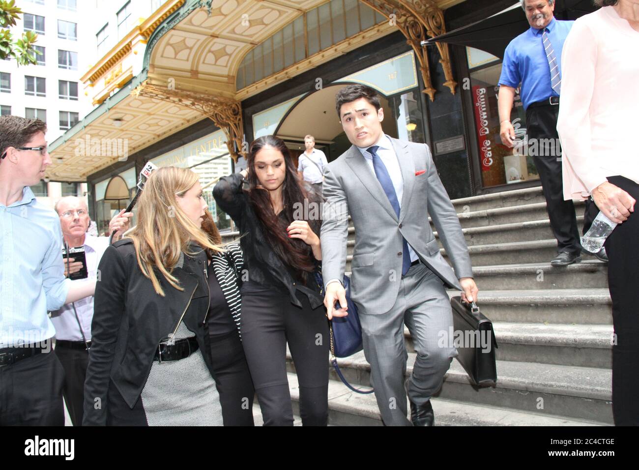 Russell Packer’s partner Lara Wilcox is surrounded by a media scrum as ...