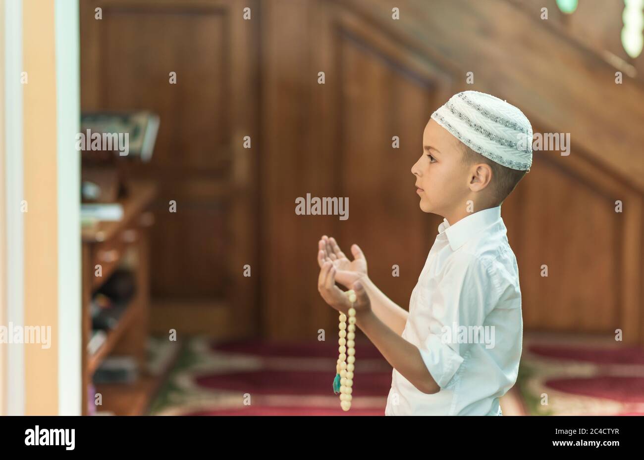 boy prays in the mosque during the month of Ramadan Stock Photo - Alamy