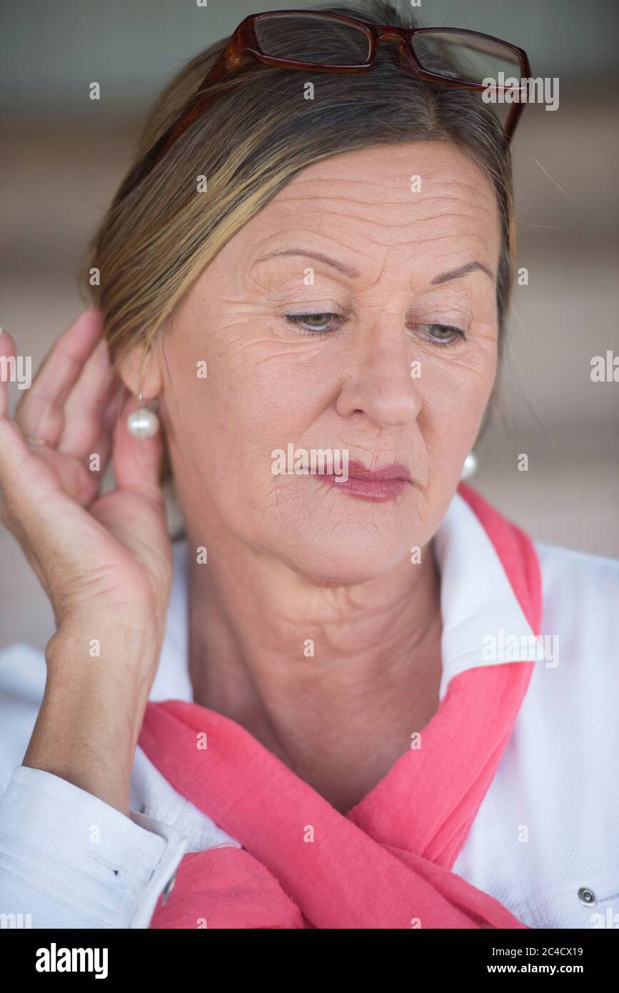 Potrait smart attractive mature business woman with glasses and serious ...