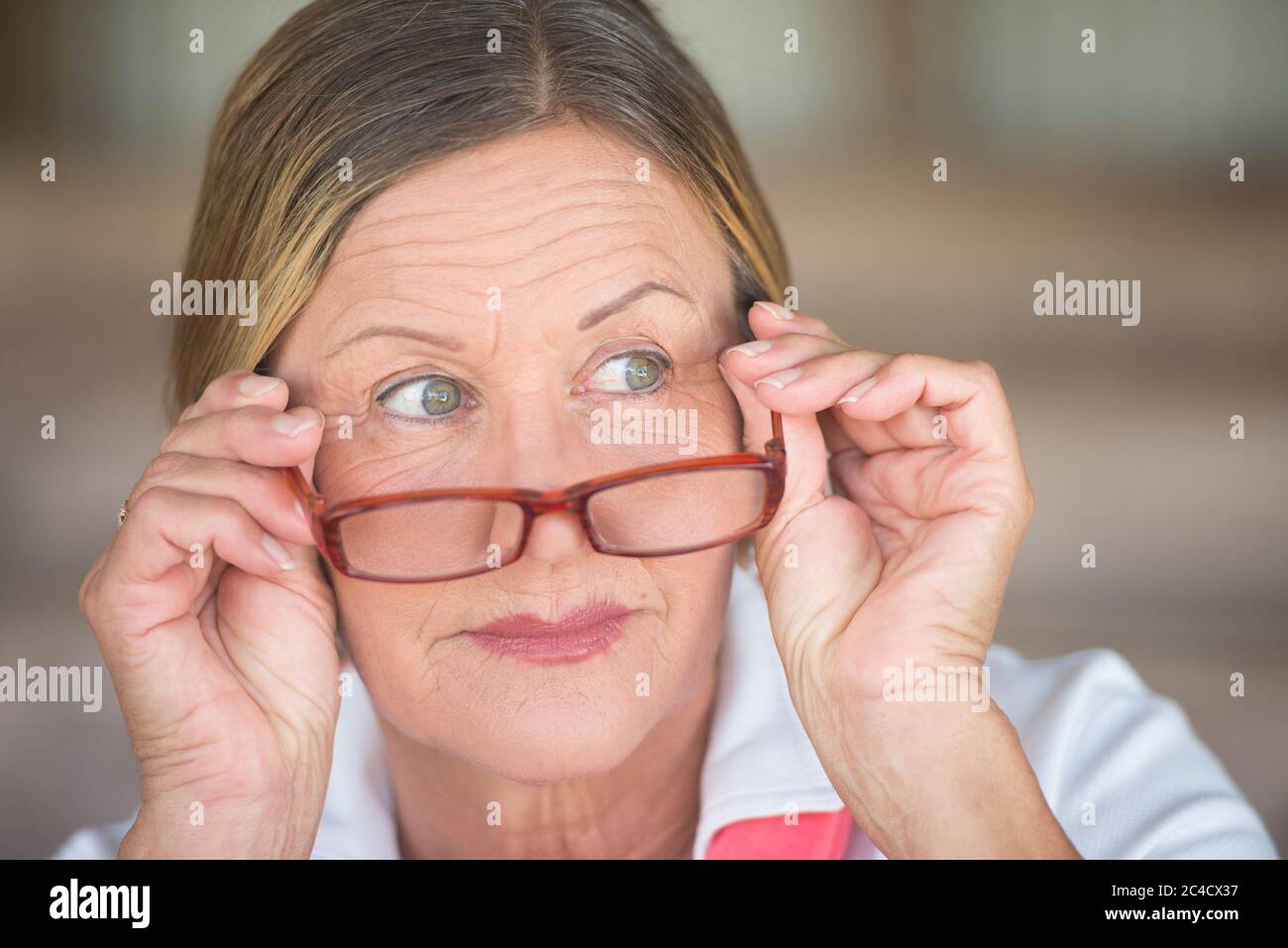 Potrait smart attractive mature business woman with glasses and curious ...