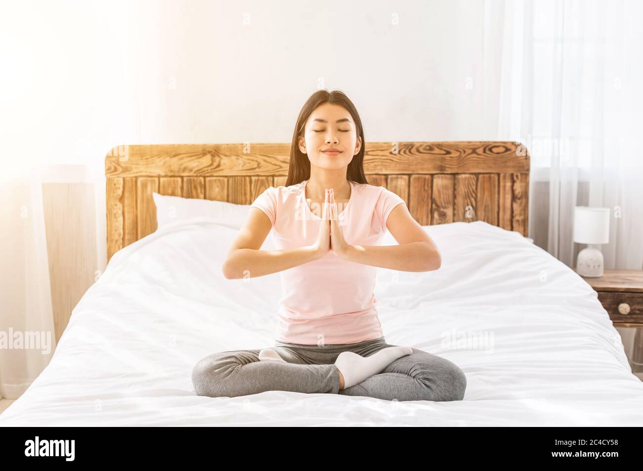 Girl Relaxing Doing Yoga Sitting In Lotus Position At Home Stock Photo ...