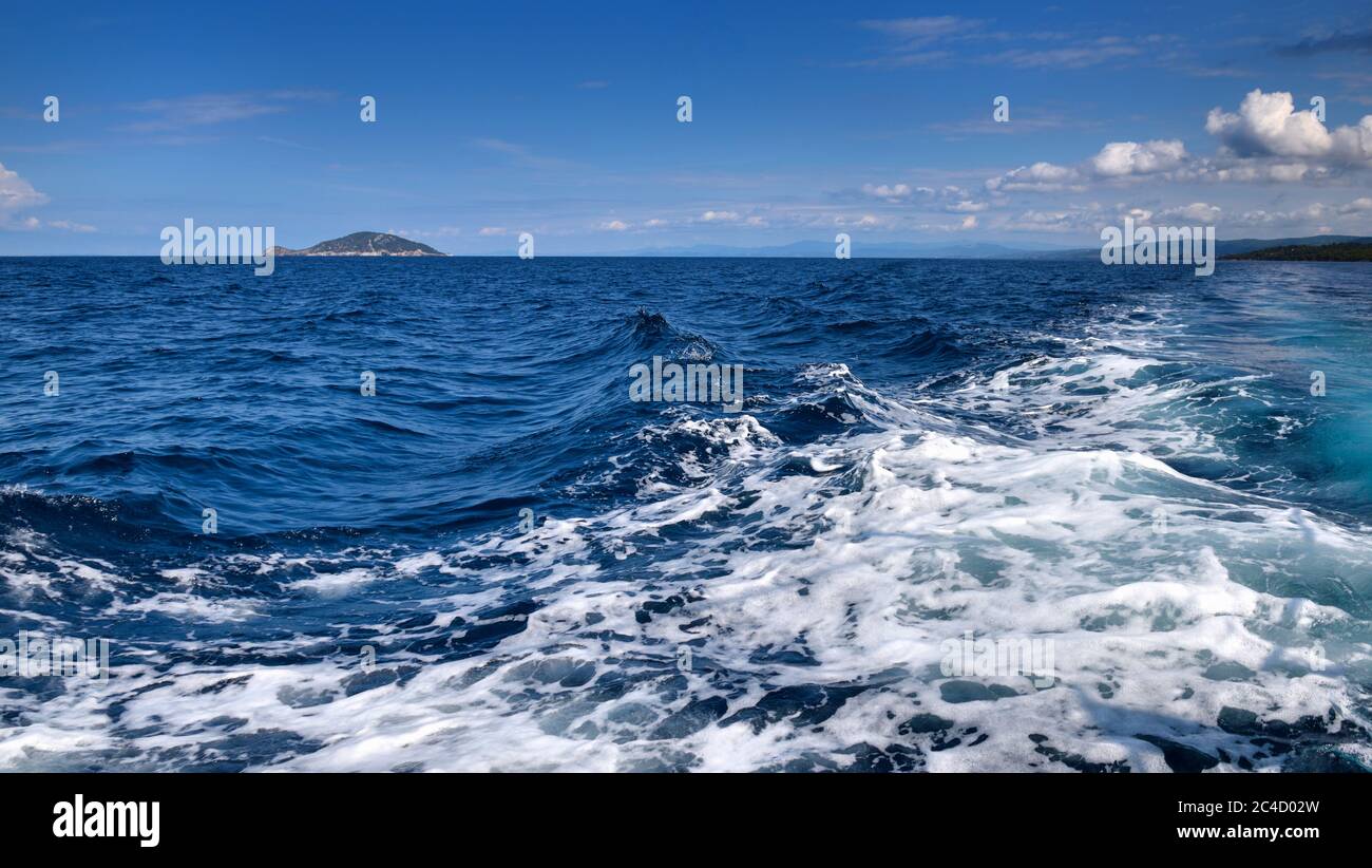 Landscape with the sea, island and beautiful clouds in the blue sky ...