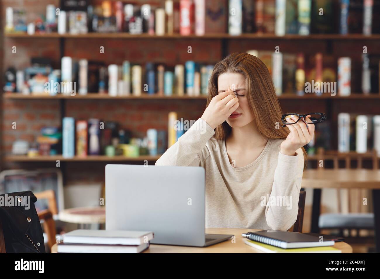 Tired girl student with headache, feeling sick while studying Stock ...