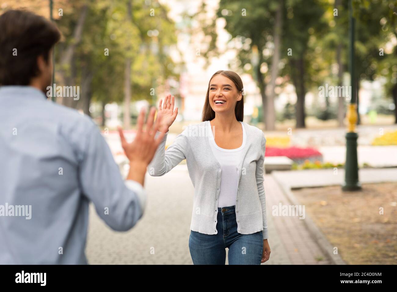 Lady waving greeting friends hi-res stock photography and images - Alamy