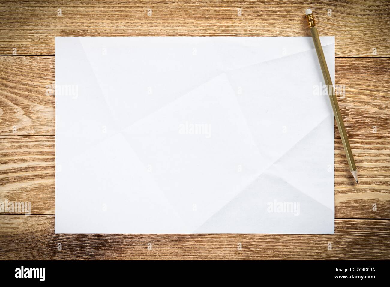 Sheet of paper lying on wooden table Stock Photo - Alamy