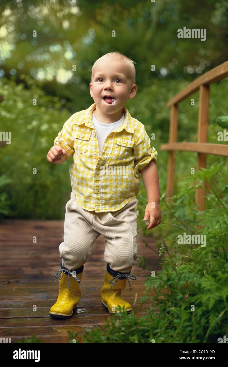 Boy yellow rubber boots hi-res stock photography and images - Alamy