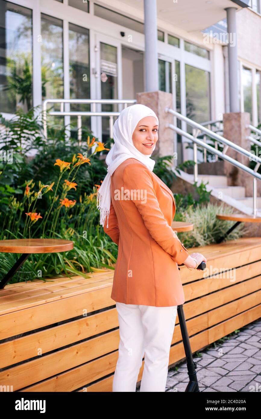 Muslim woman riding a scooter hi-res stock photography and images - Alamy