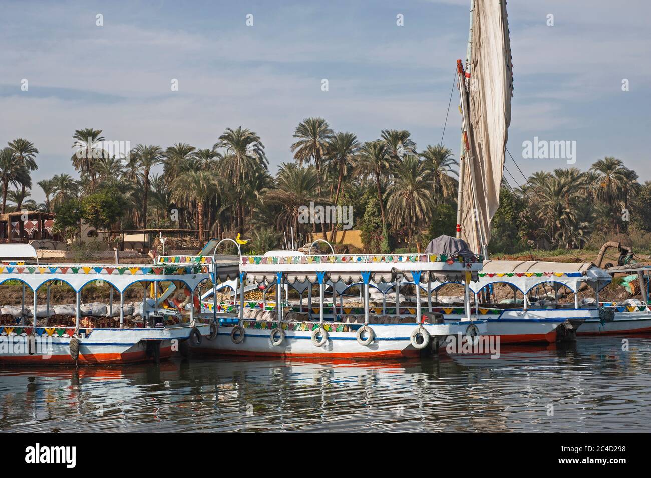 Traditional egyptian felluca sailing boat on river Nile with reflection ...