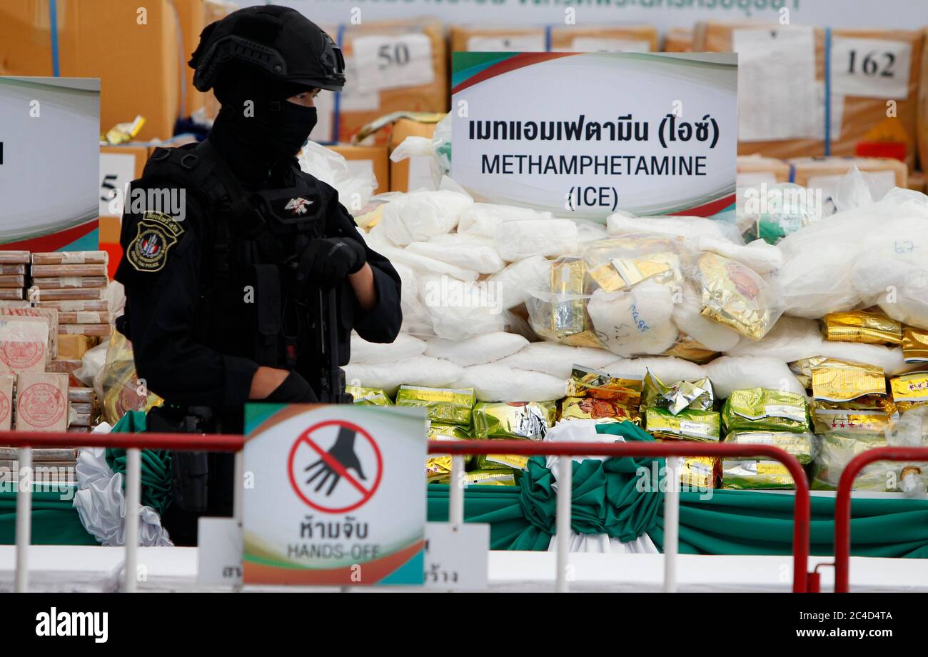 A Thai police officer guards bags of confiscated narcotics drug during ...