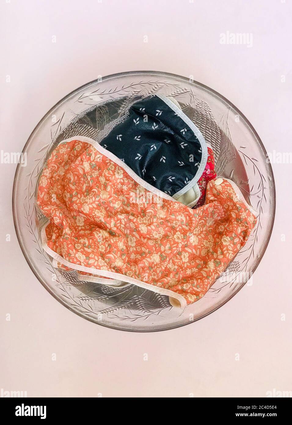 Vertical closeup of reusable menstrual/period pads soaking in water ...