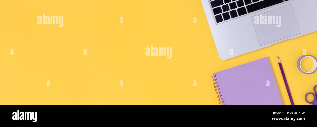 Banner with laptop, glasses, notepad and stationery on a bright yellow ...