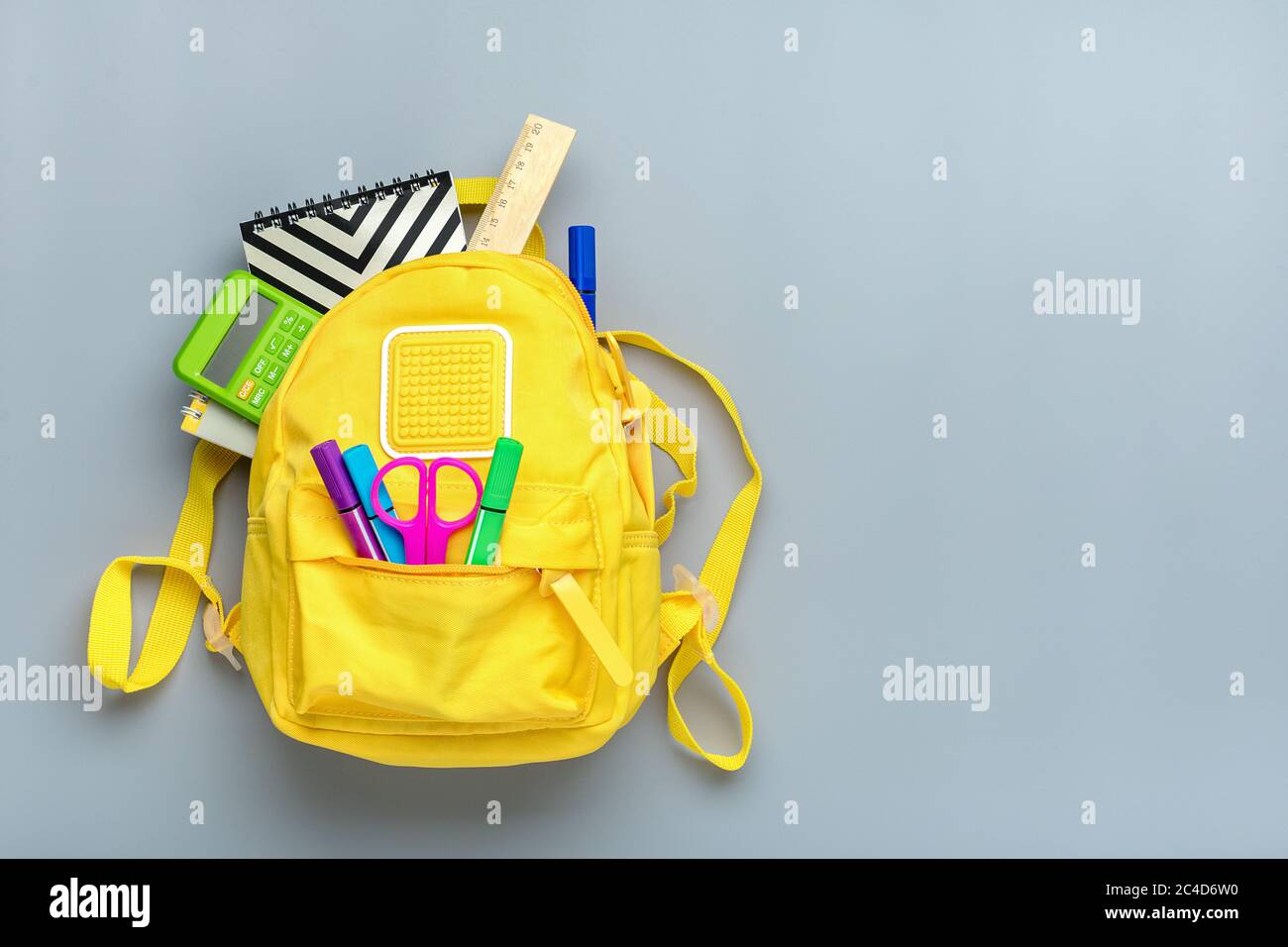 Back to school, education concept. Yellow backpack with school supplies ...