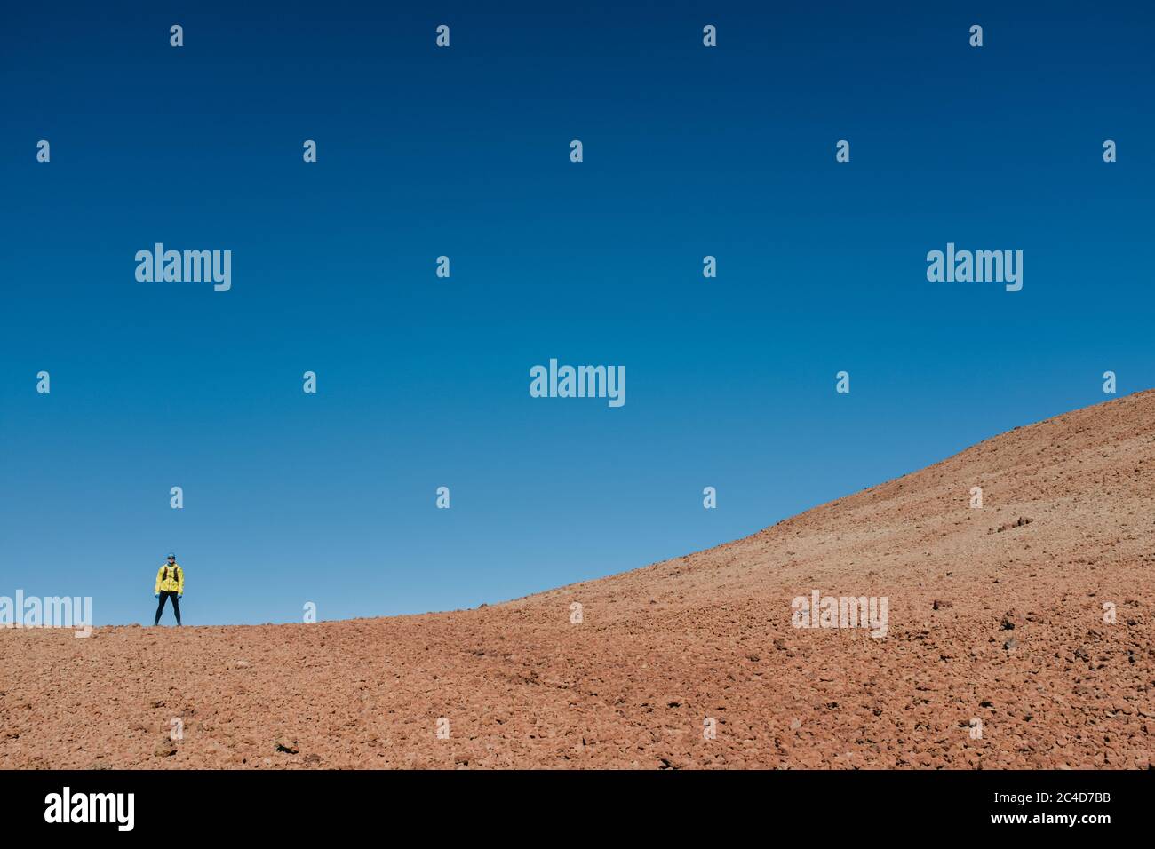Man running in desert trail training marathon in amazing volcano desert ...