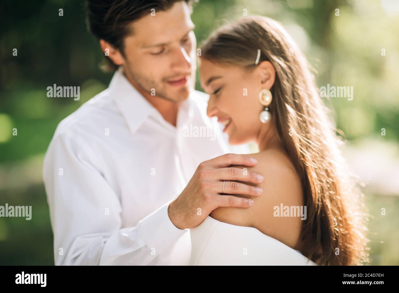Groom Hugging Bride Before Kiss At Outdoor Wedding Ceremony Stock Photo ...