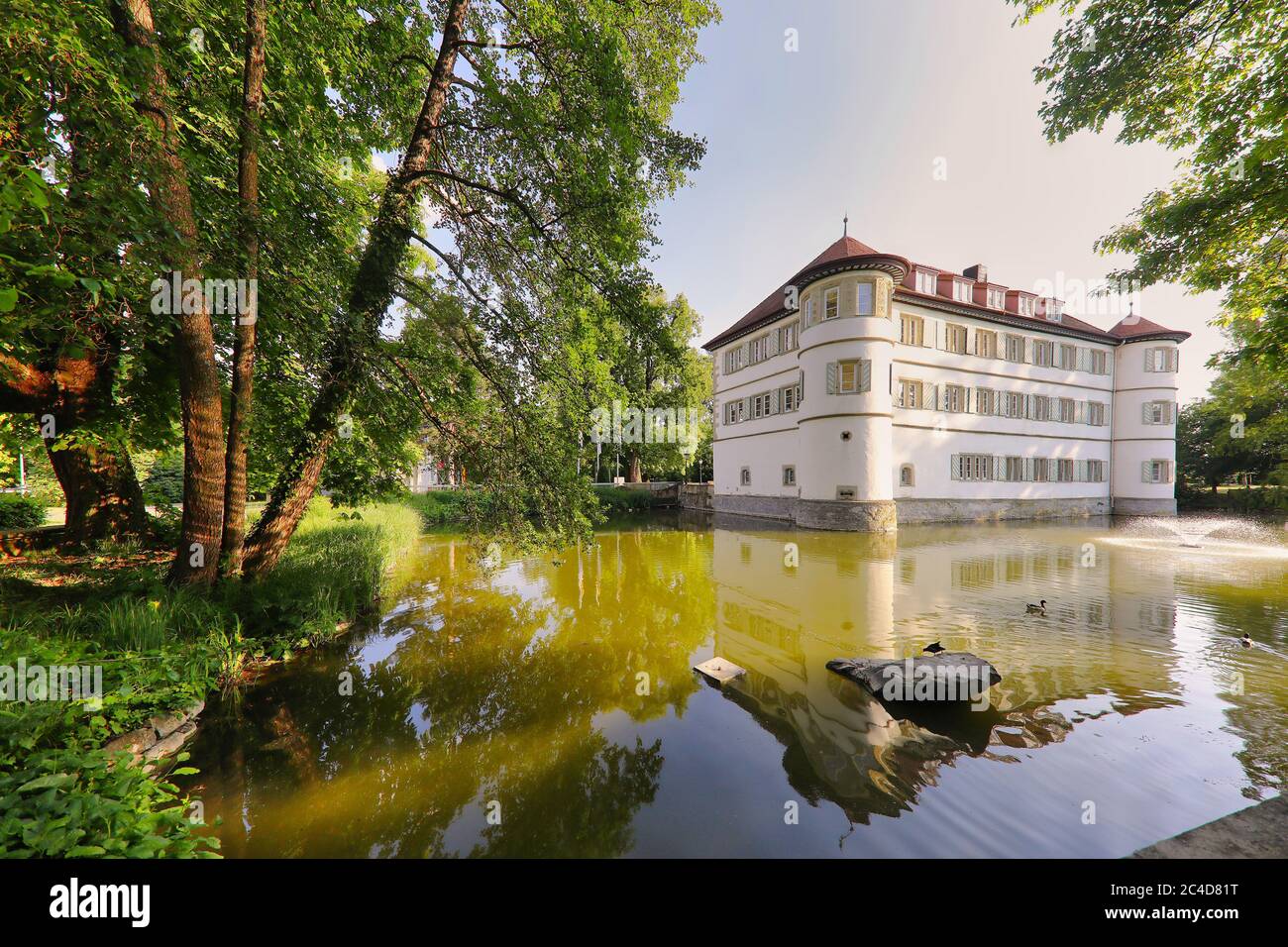 View of the Moated Castle surrounded with trees in Bad Rappenau ...