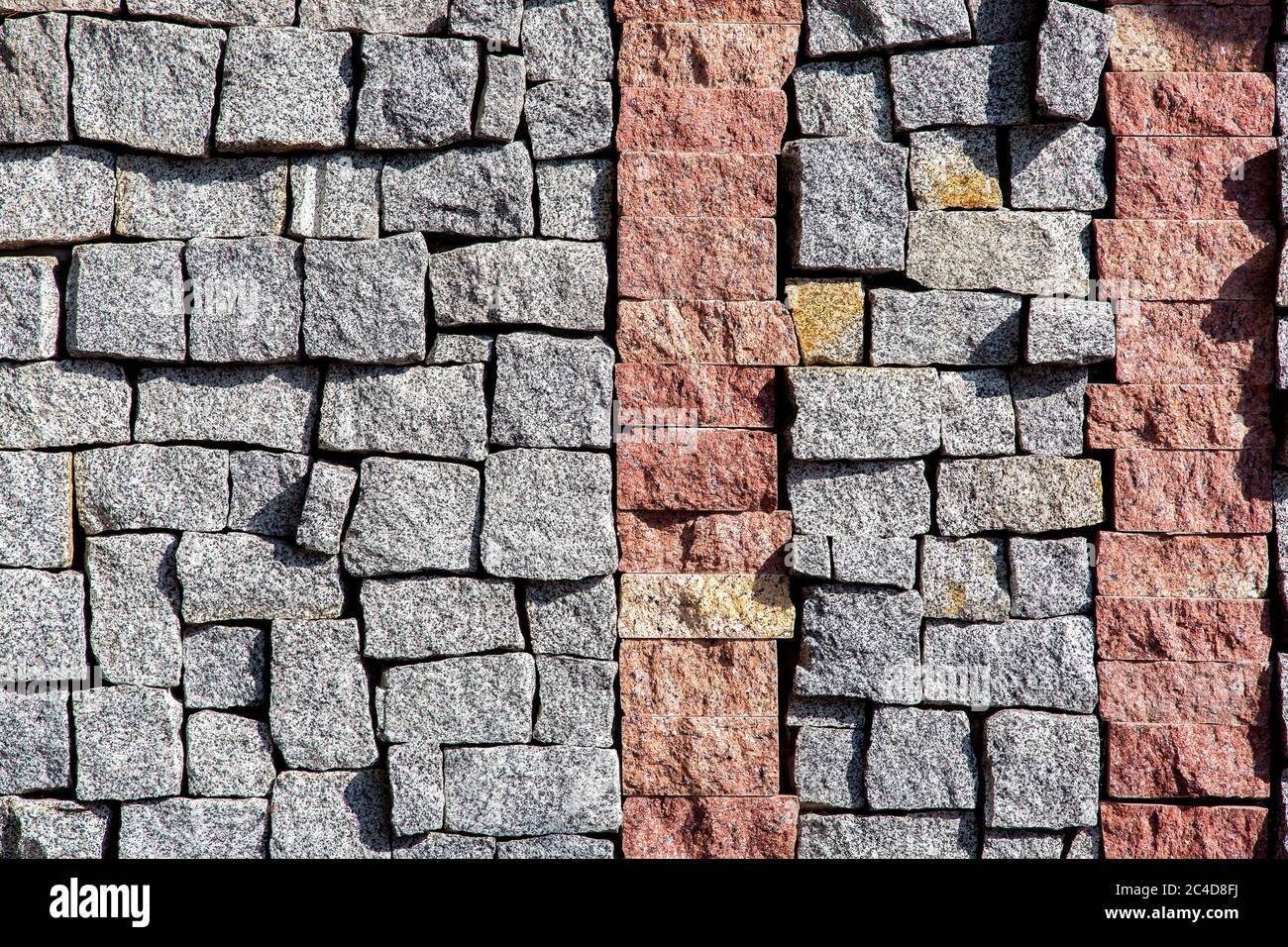 granite blocks of different sizes paved on the wall with a stone ...