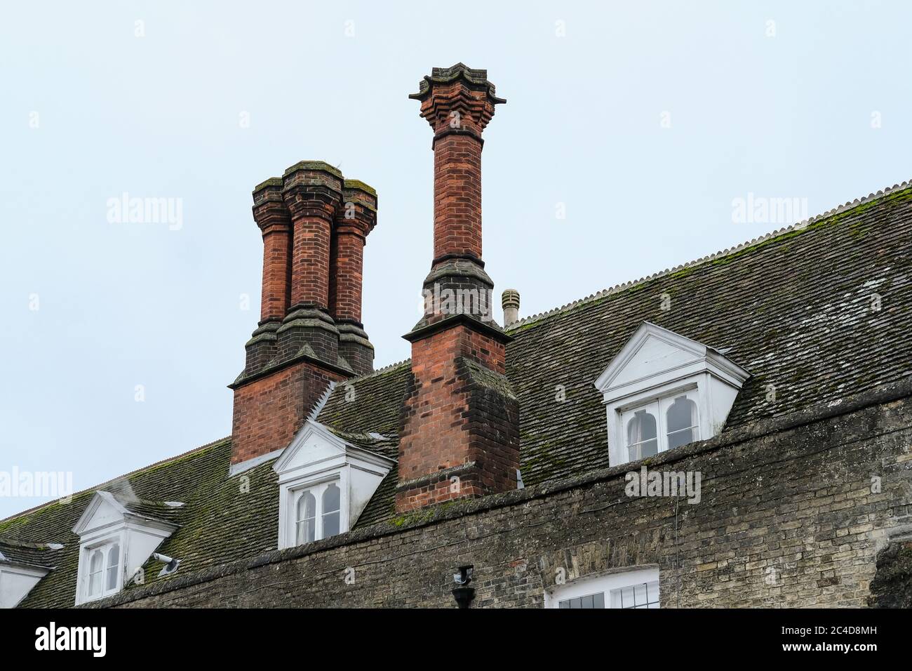 Unusual but highly architectural chimneys seen atop a large, brick ...