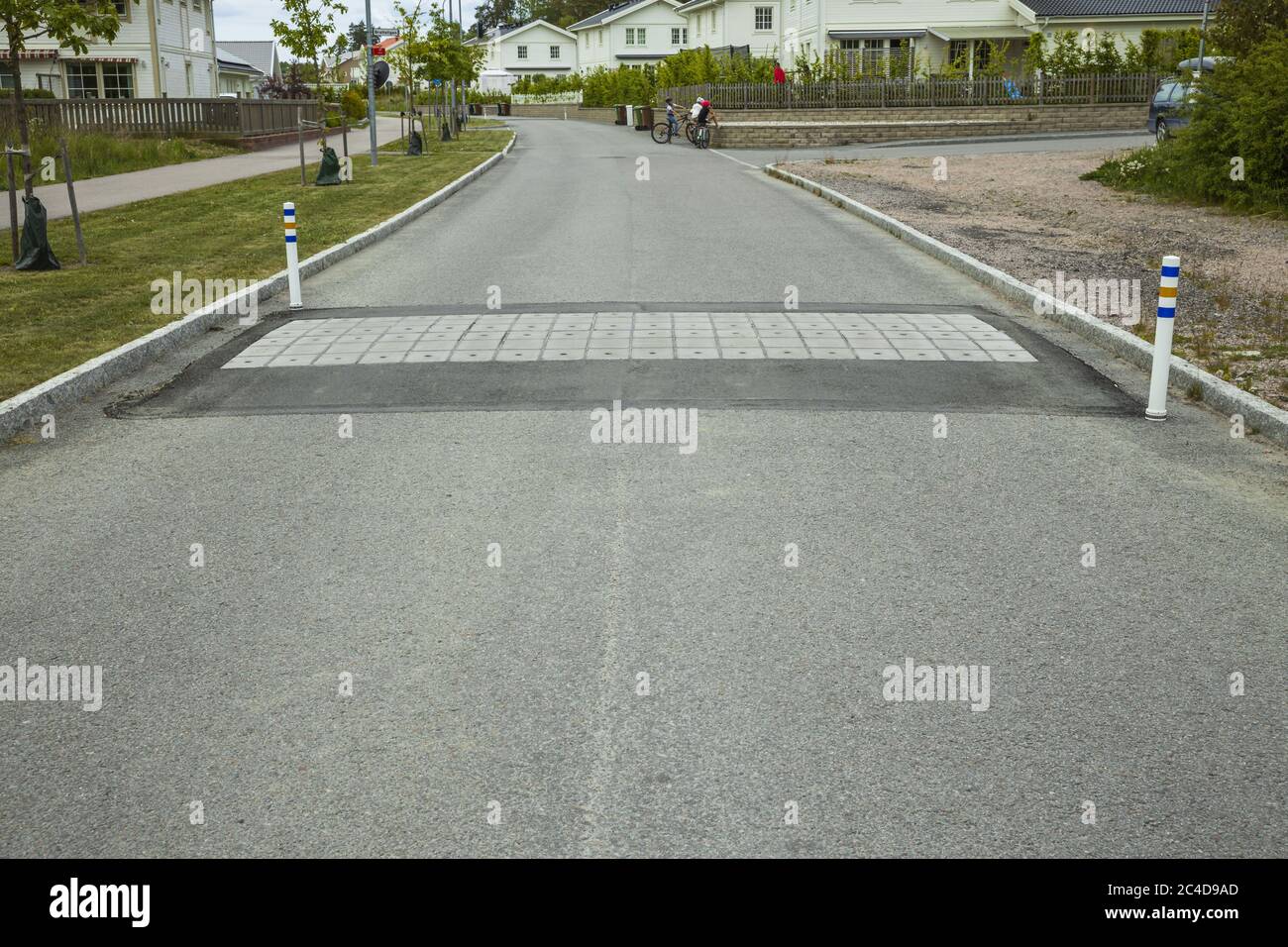 Close up view of speed bump on village street road. Landscape view ...