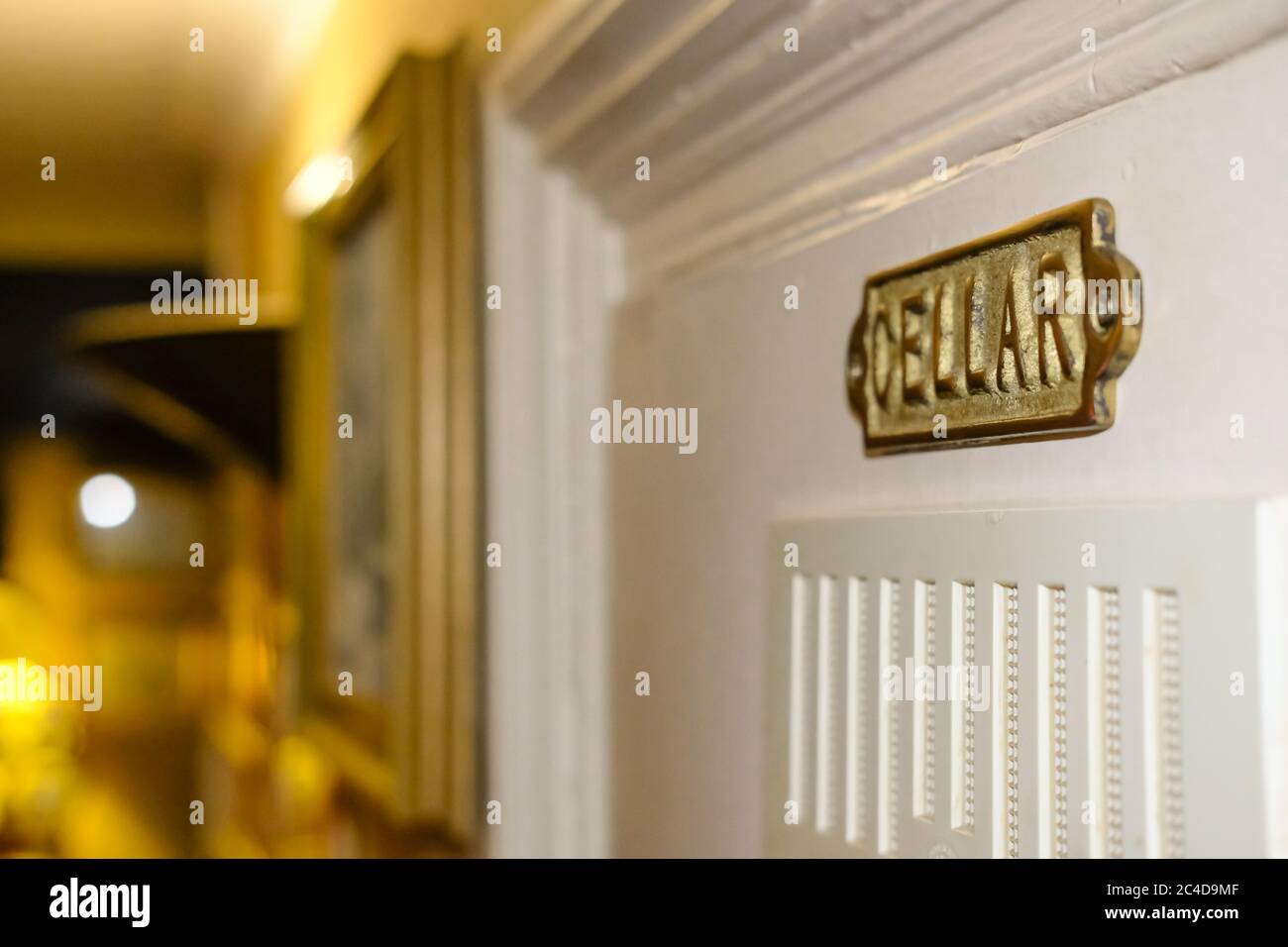 Shallow focus of a brass Cellar sign attached to an inner doorway ...