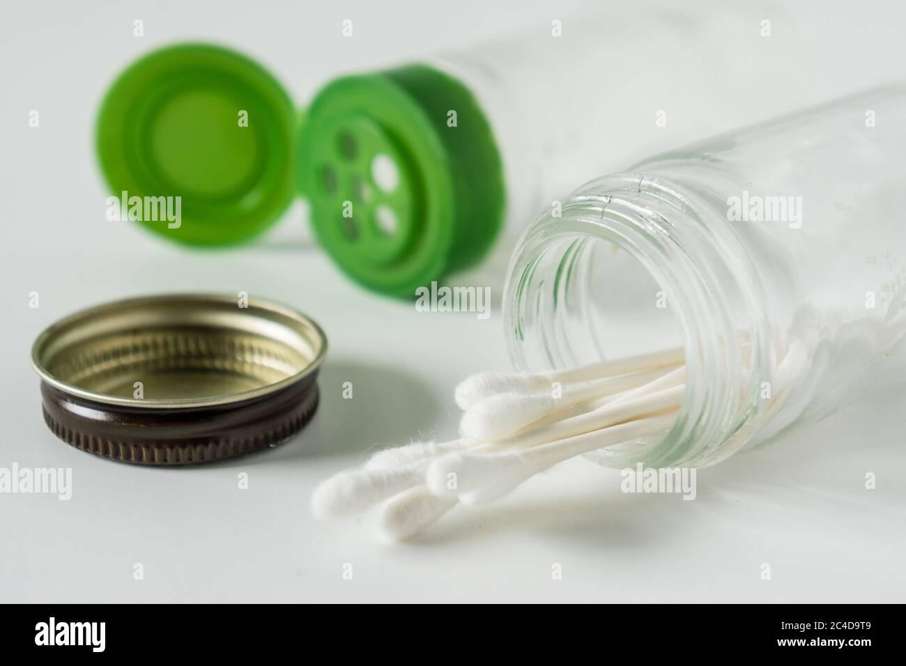 Closeup shot of ear sticks in a transparent container on a white ...