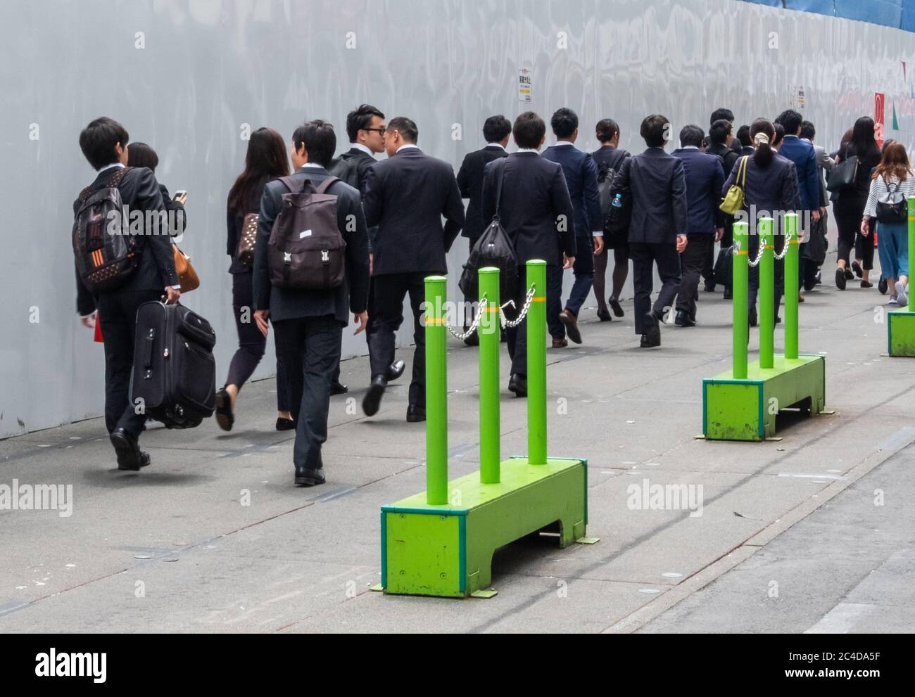 A group of Japanese salaryman or office worker in Shibuya street, Tokyo ...