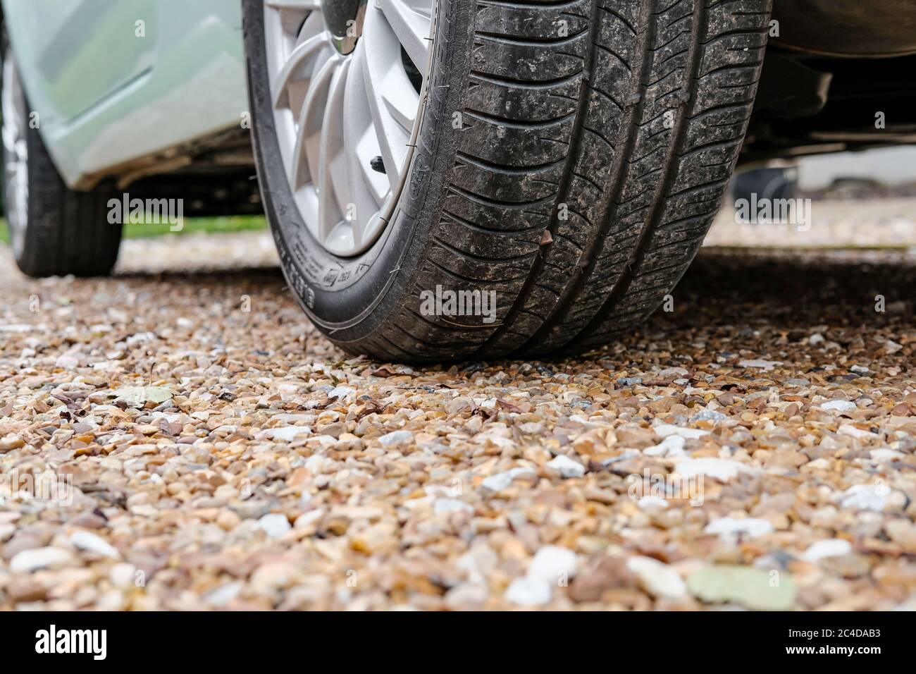 Ground level view of a new car, showing the rear tyre and tread ...