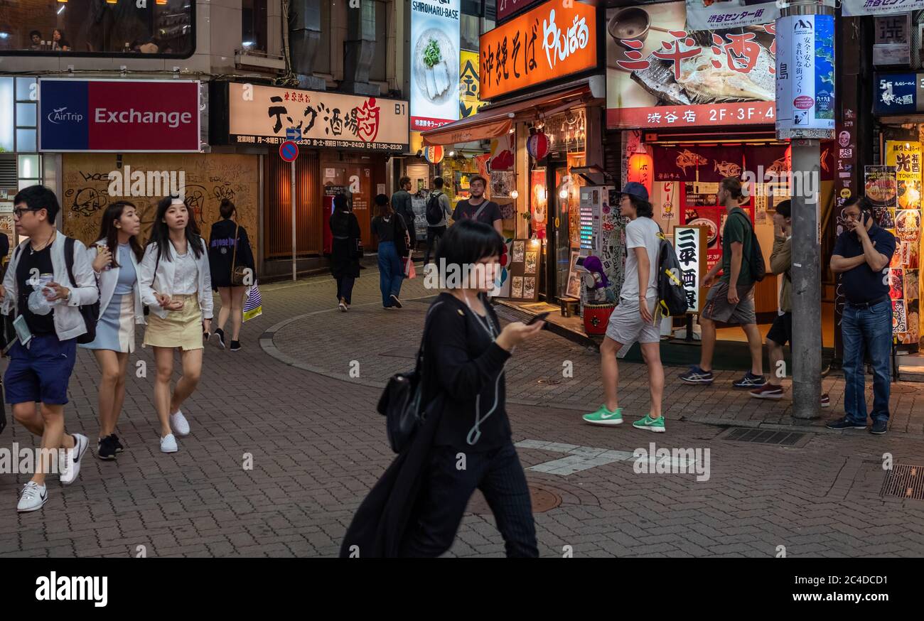 Pedestrian walking in Shibuya back alley street, at night, Tokyo, Japan ...