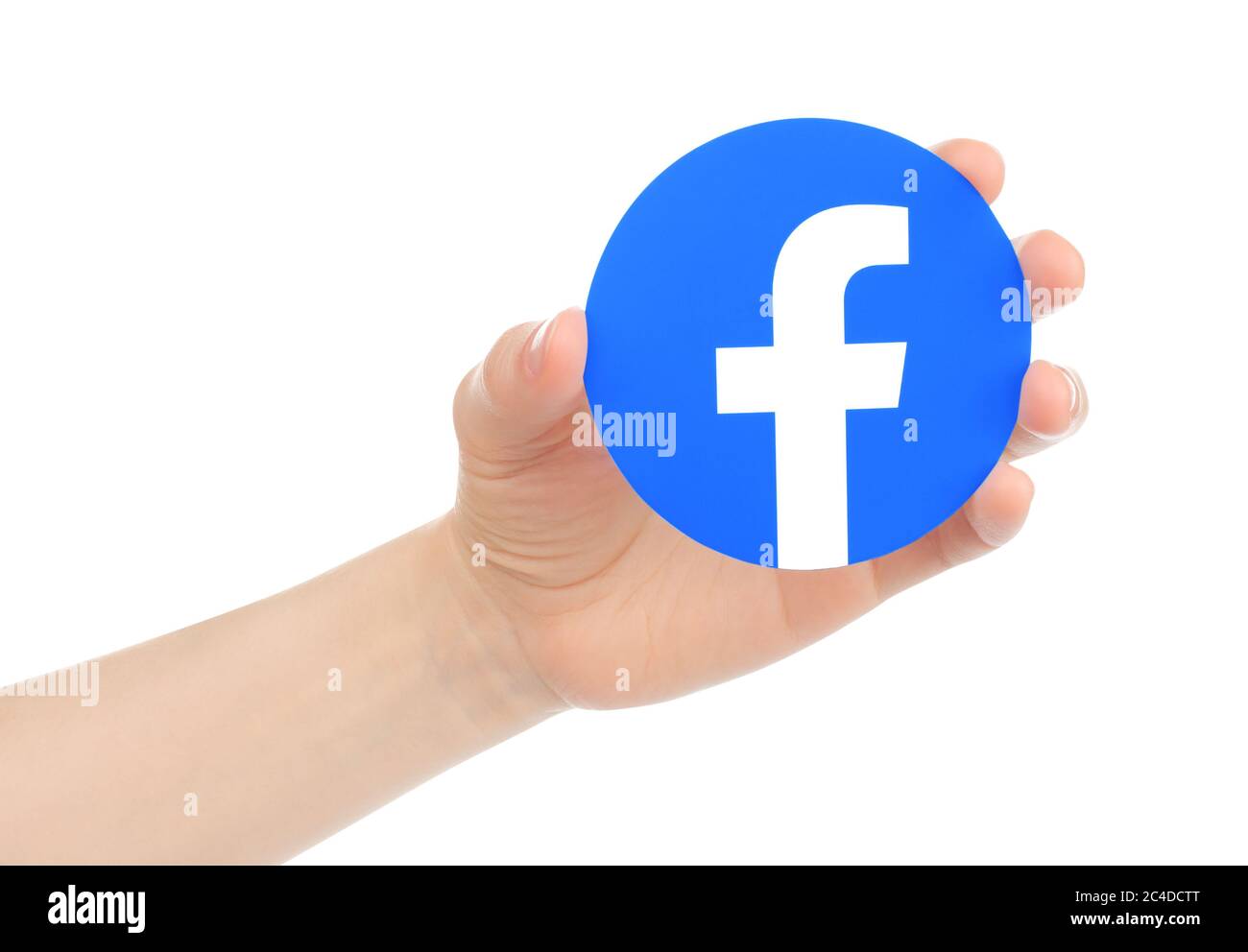 Kiev, Ukraine - May 15, 2019: Hand holds New Facebook logo printed on ...