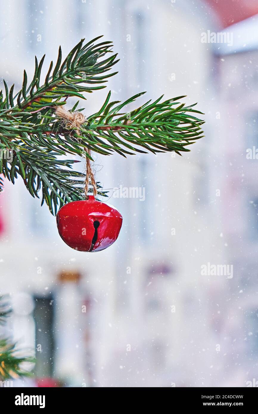 Red Christmas bell hanging on branch of Christmas tree on blurred ...