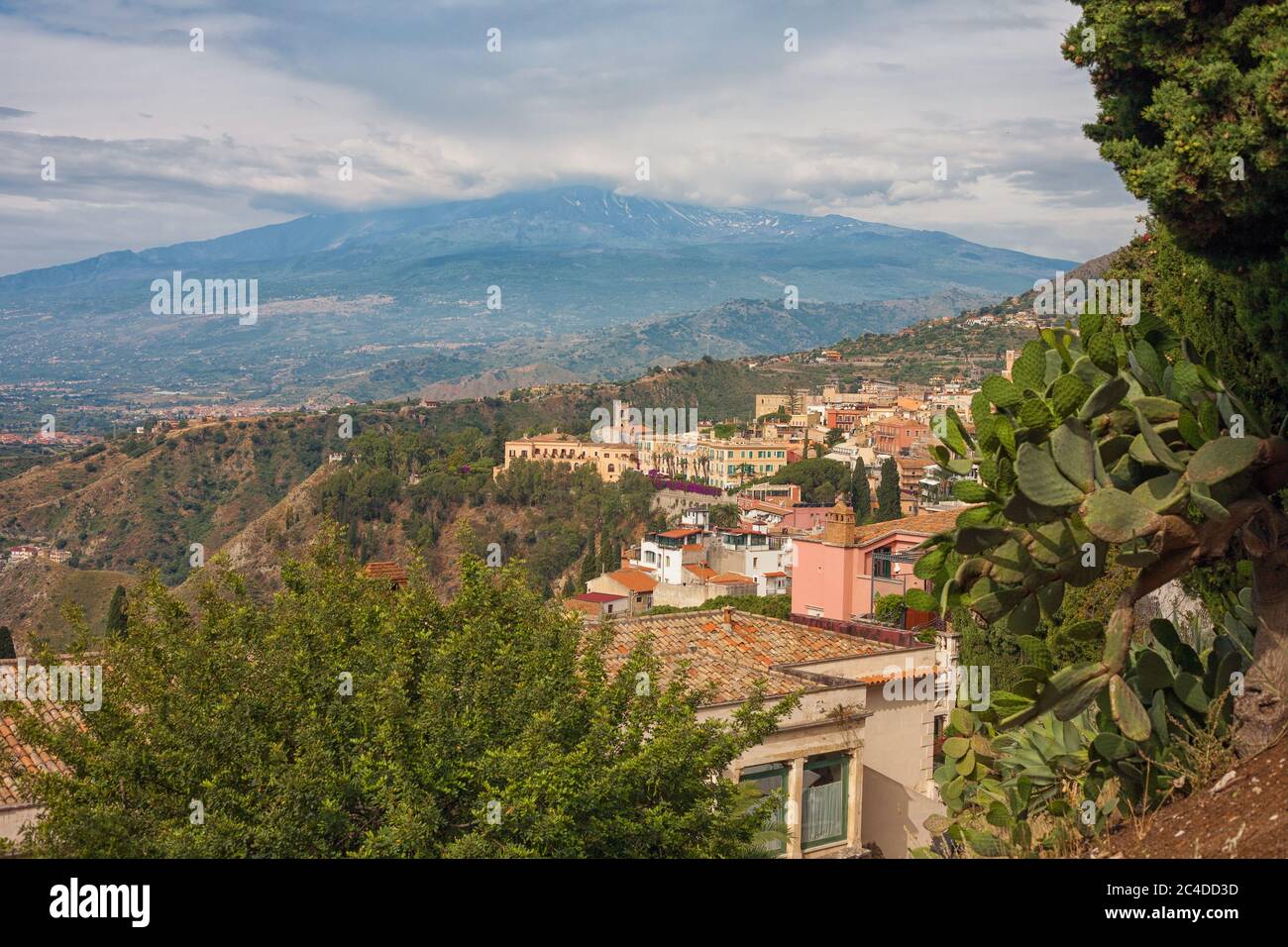View of Taormina from the greek amphitheatre with the Etna Volcano in ...