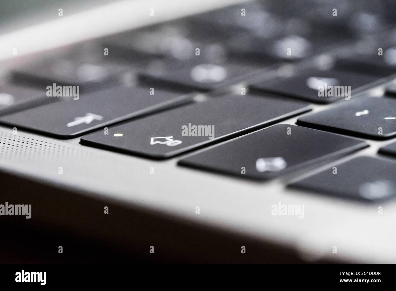 Close-up, shallow focus of a back-lit keyboard seen on a well-known ...
