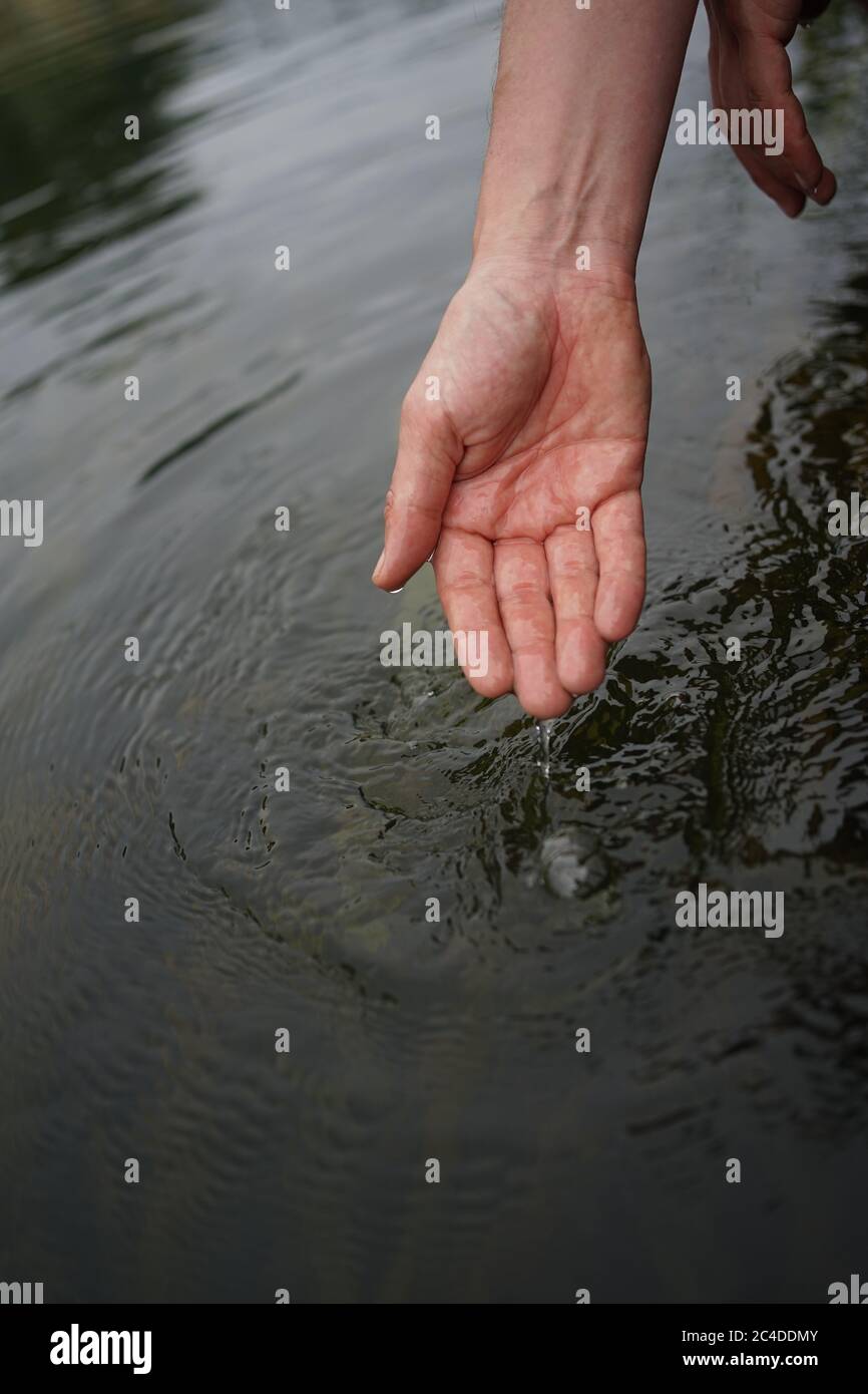 Hands dipping in river water Stock Photo - Alamy